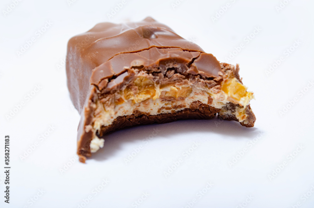 A piece of sneakerskie bitten on a white background teeth marks. One ...