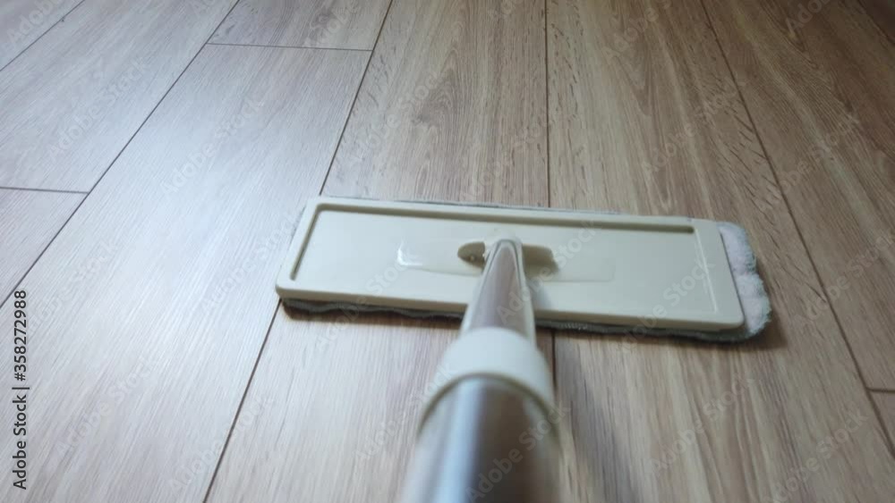 Microfiber Dust Wet Mop move around the floor close-up 4K. Top view POV ...