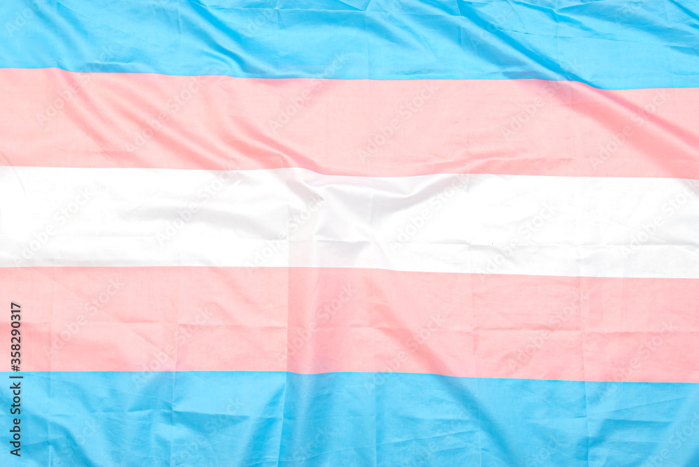 Transgender fabric flag with white, pink, blue strips. Close-up ...