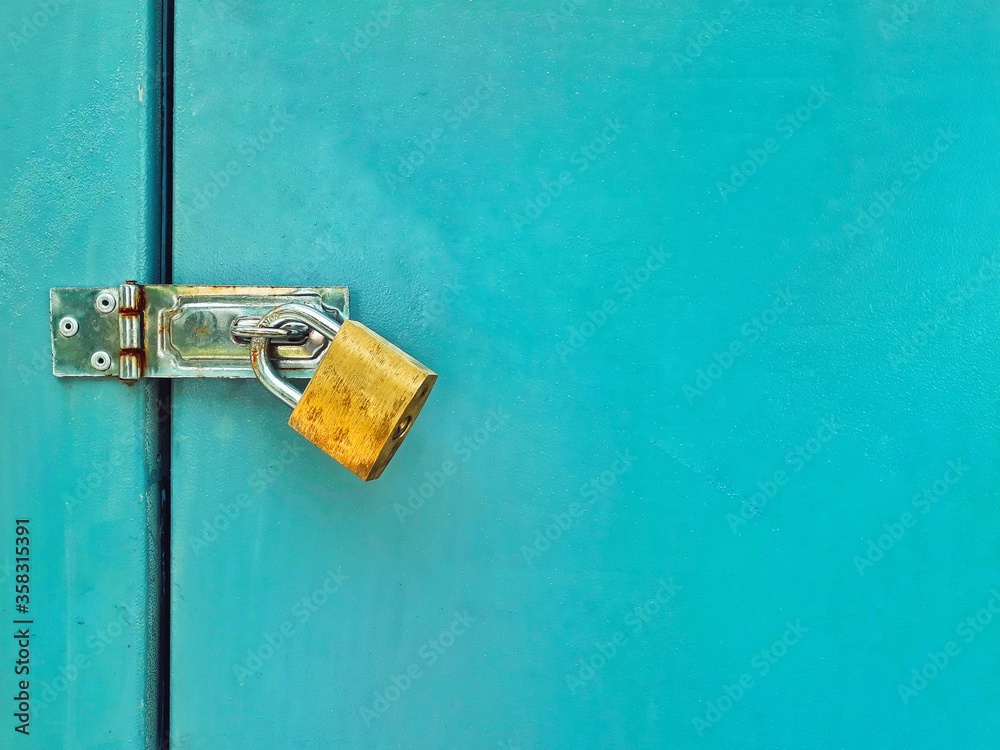 Rusty golden lock with locked blue metal door texture background with ...