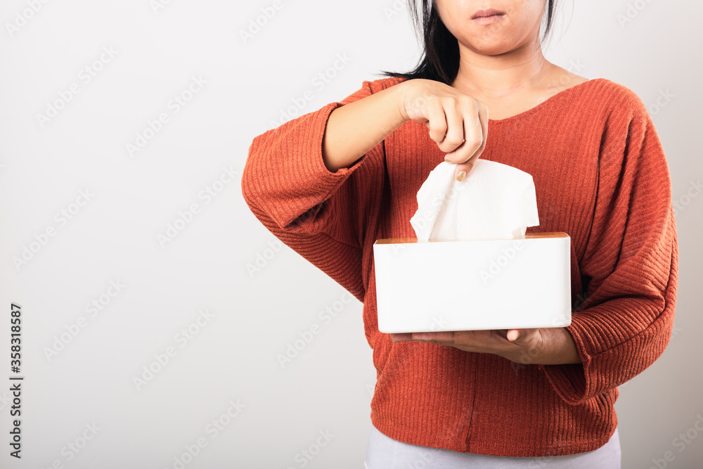 Young woman flu she using hand taking pulling white facial tissue out ...
