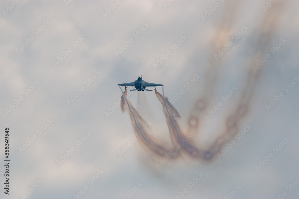 Jet aircraft during airshow aerobatic display with smoke Stock Photo ...