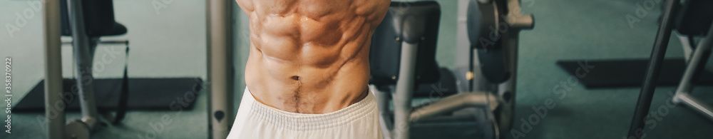 Handsome power athletic man on diet training pumping up muscles with ...