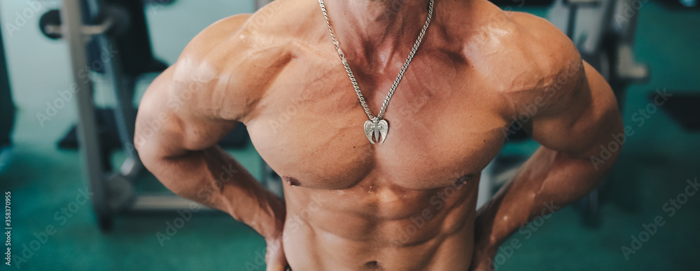 Handsome power athletic man on diet training pumping up muscles with ...