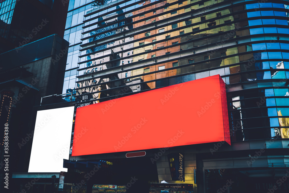 Tall modern building with glass exterior and billboard with copy space ...