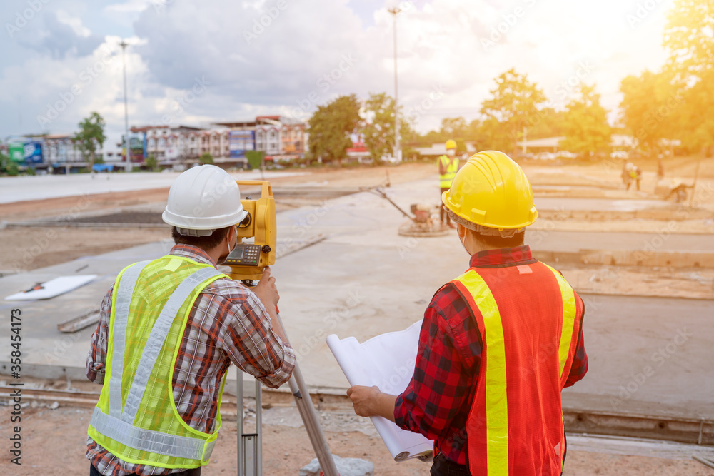 Backside engineer team working the surveyor at the construction site ...