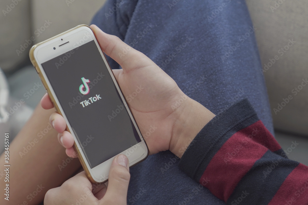 Teen boy hands holding smartphone with Tik Tok app on screen on June 17 ...
