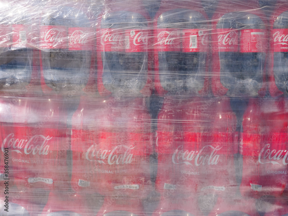 Six packs of Coca Cola bottles on a pallet, ready for distribution ...