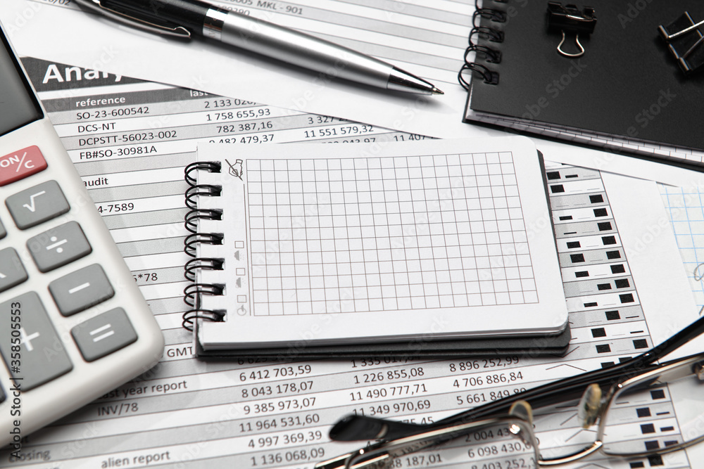 Top view of office employee's desk - work with financial reports ...