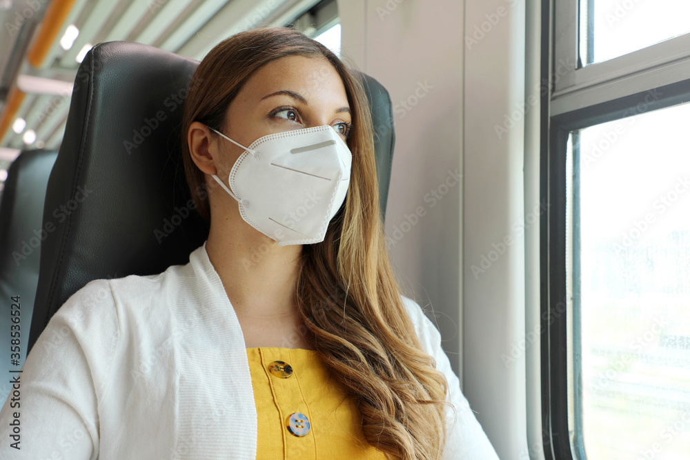 Travel safely on public transport. Young woman with KN95 FFP2 face mask ...