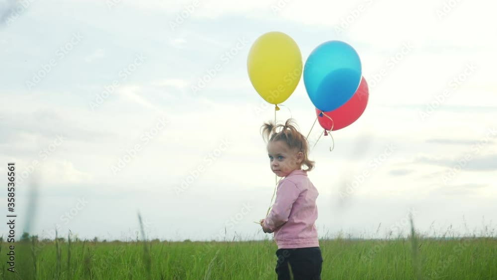 lonely daughter little girl holding balloons a on her birthday. happy ...