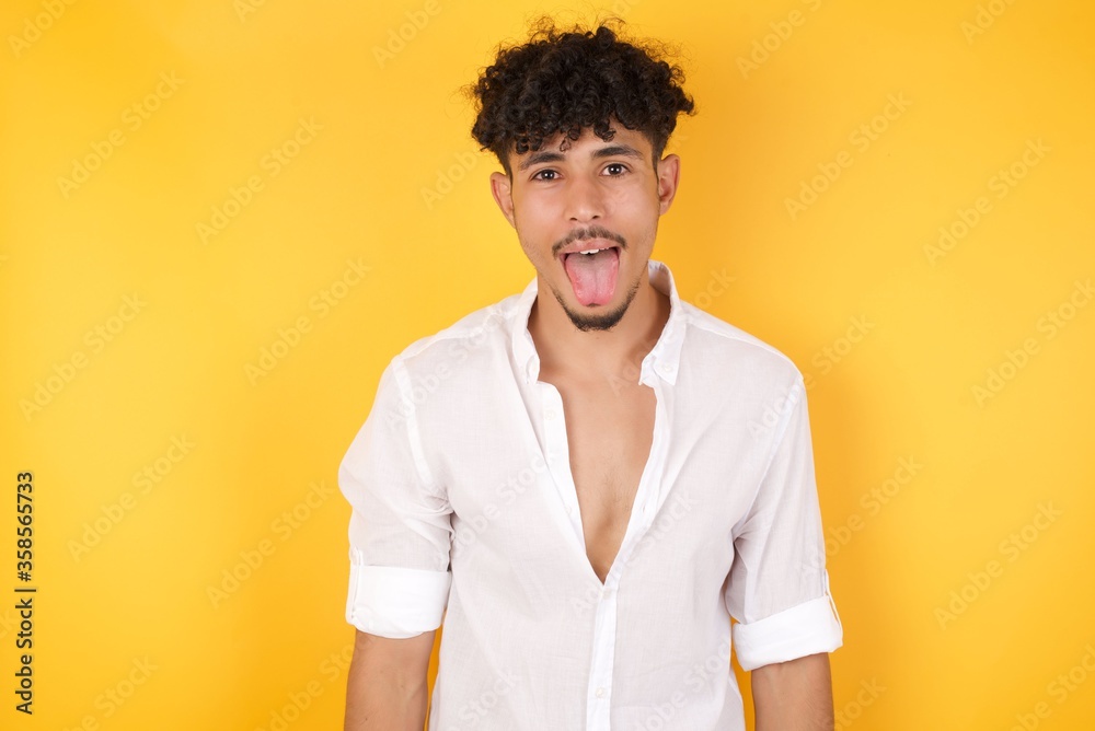 Body language. Disgusted stressed out pretty man posing against gray ...