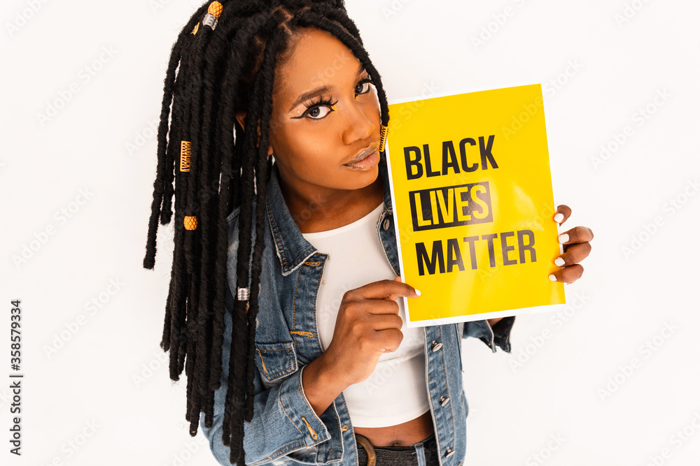 Demonstrator fashionable black woman hold banner with the motto of the ...