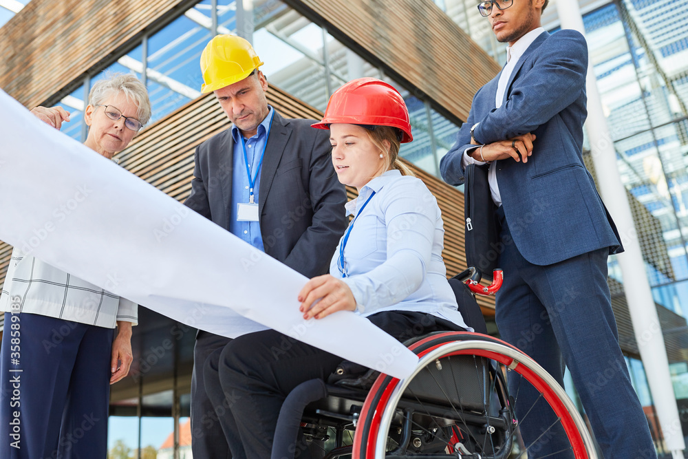 Disabled architect in a wheelchair and engineers Stock Photo | Adobe Stock