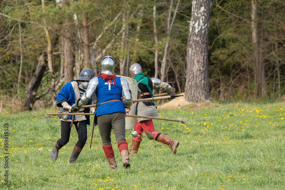 Knights in armor fight on the battlefield. Reconstruction of an ancient ...
