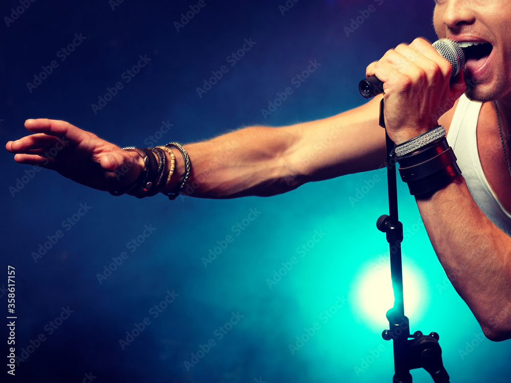 Young Man Singing at rock Concert Stock Photo | Adobe Stock