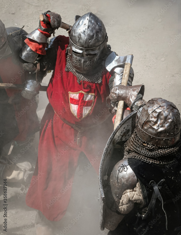 Warriors in knight armor fighting on battlefield, reenactment of ...