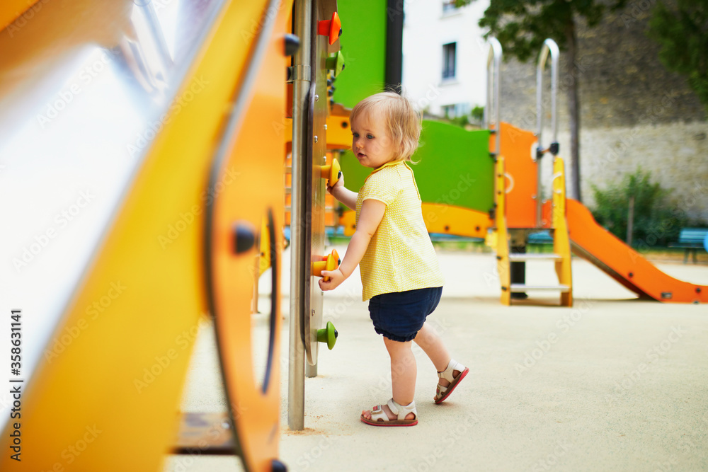 Adorable toddler girl on playground near slide Stock Photo | Adobe Stock