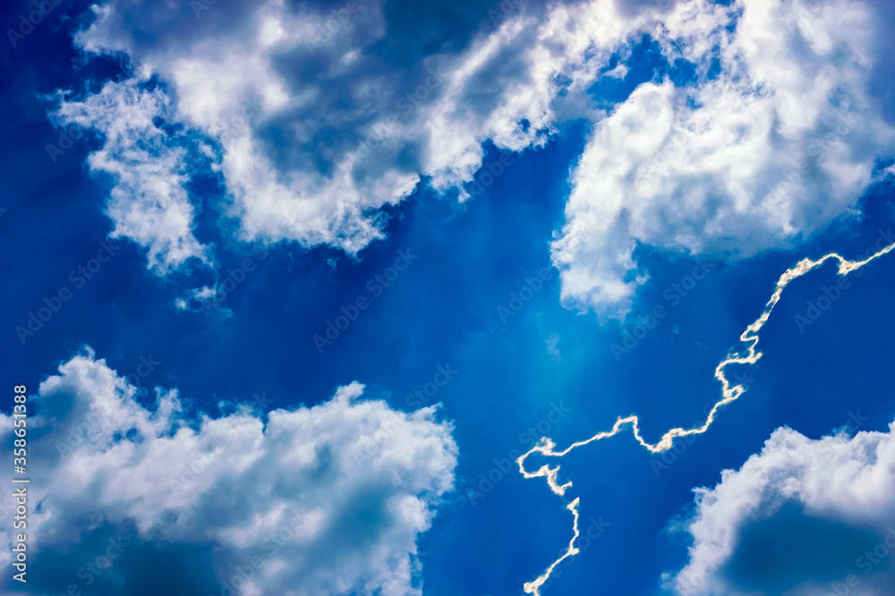 Lightning sparkles in the dark blue sky with cumulonimbus clouds ...