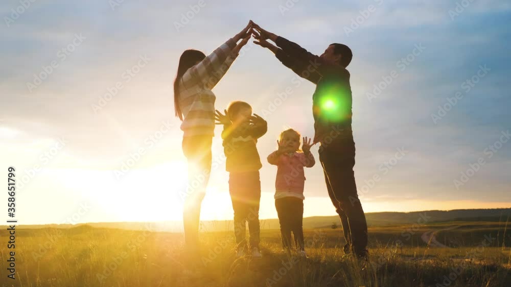 happy family. teamwork adult parents and small children shows a house ...