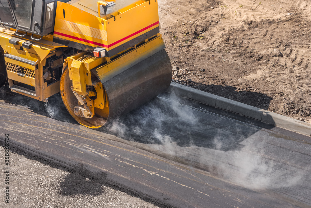 Road construction machinery: road roller or paver machine compacts the ...