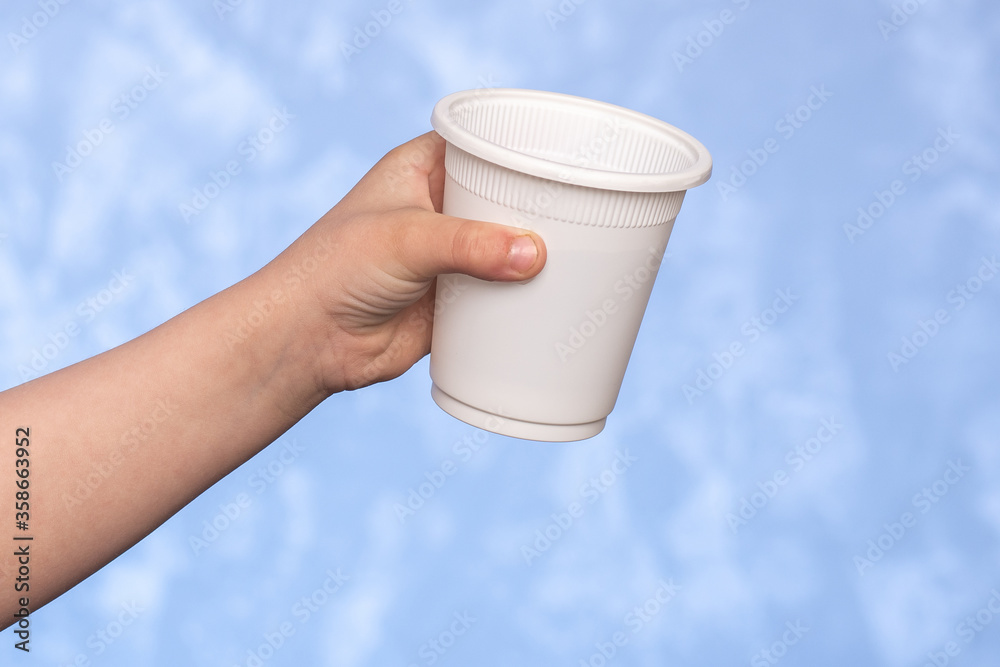 biodegradable disposable cup in a male hand. corn starch dishes ...