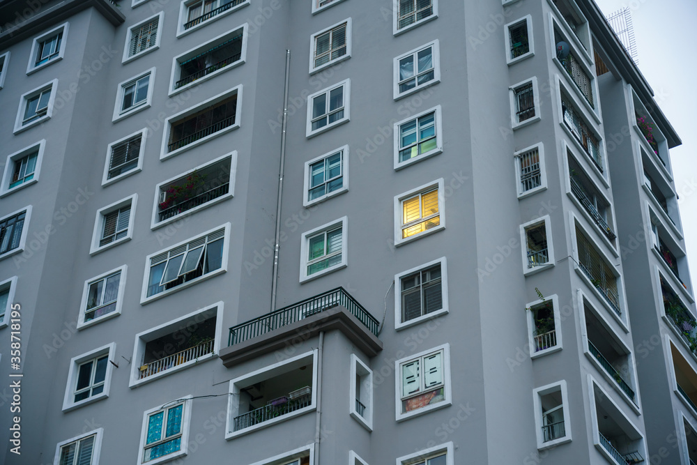 Liht in a single window of an apartment building at dawn Stock Photo ...