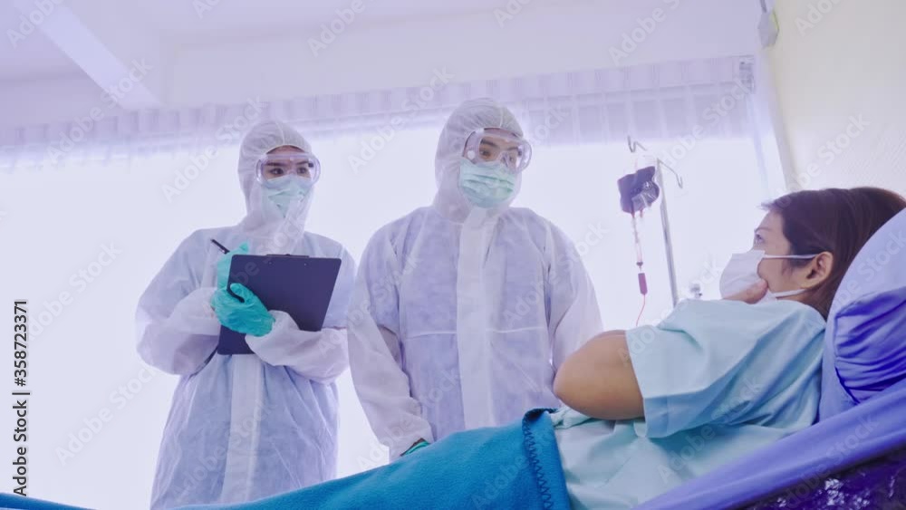 The doctors are examining the Asian female patient Who lay down on ...