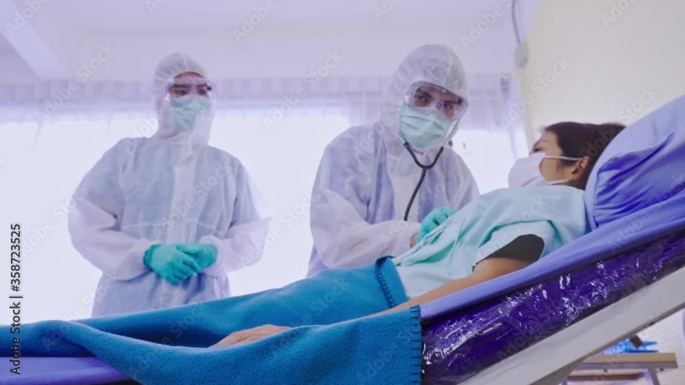 The doctors are examining the Asian female patient Who lay down on ...