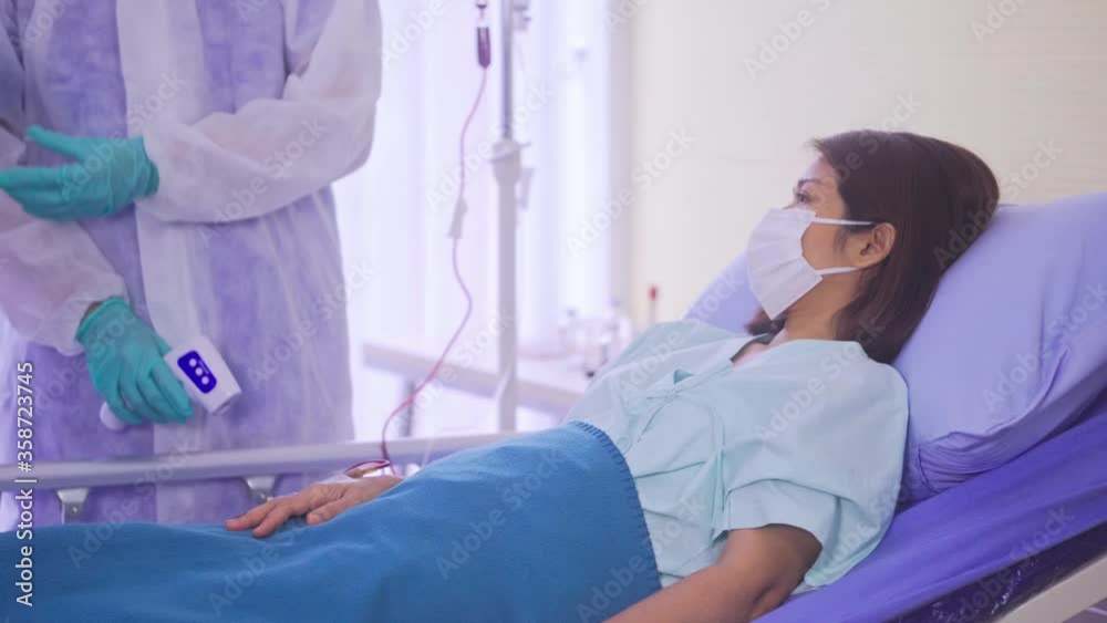 The doctors are examining the Asian female patient Who lay down on ...
