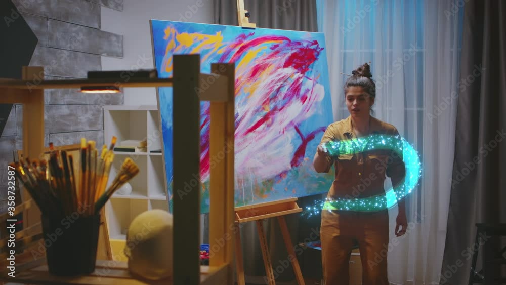 Talented female painter using augmented reality to create light ...