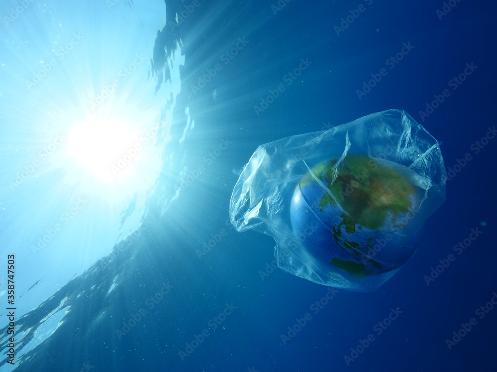 world in plastic bag drifting underwater representing ocean pollution ...