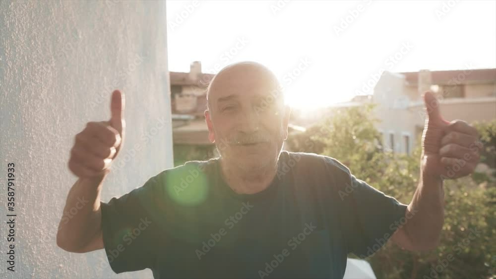 An happy, positive old man saying yes with hand gesture. Greetings ...