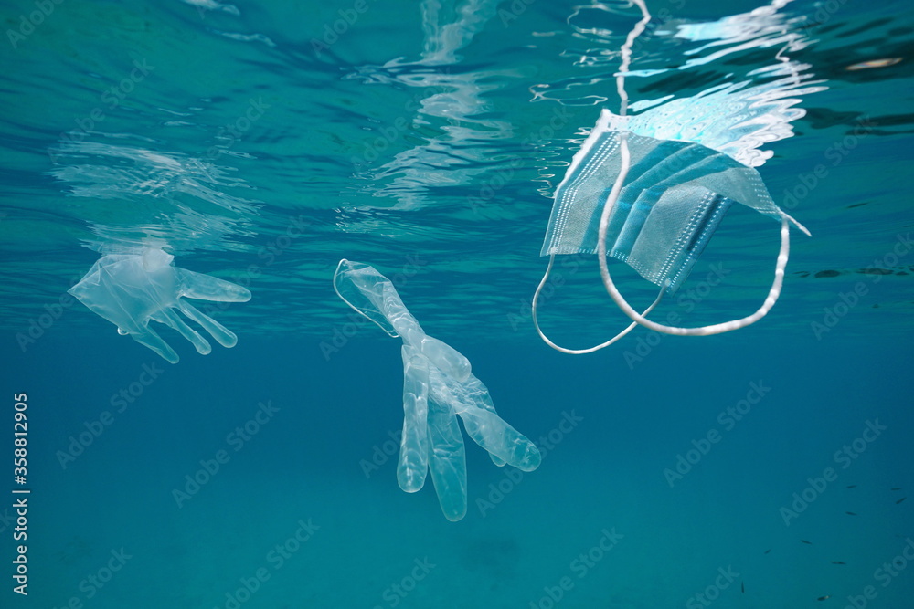 Face mask and gloves underwater in the ocean, plastic waste pollution ...