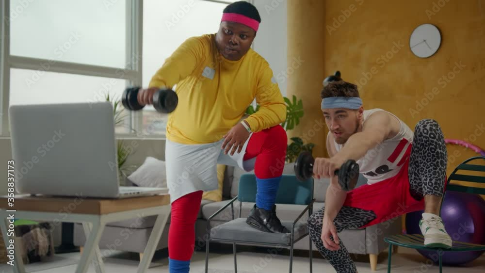 Ridiculous weird couple of fitness beginners doing arm exercises on ...