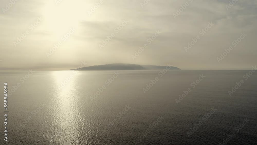 Flight across the ocean, the outlines of the island are visible in the ...