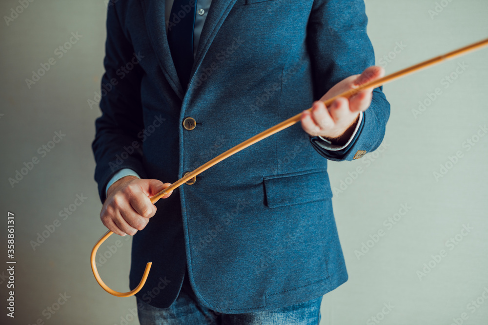 Headmaster with cane. Strict man teacher with crooked rattan cane ...