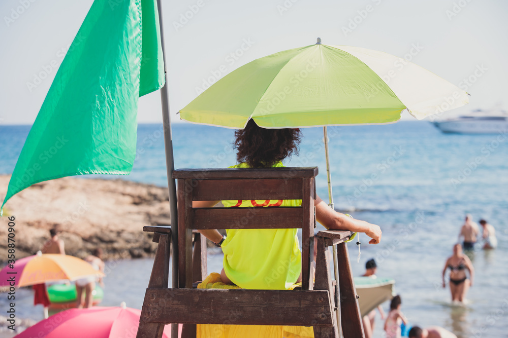 Lifeguard rescue worker on duty, on a baywatch tower safeguarding and ...