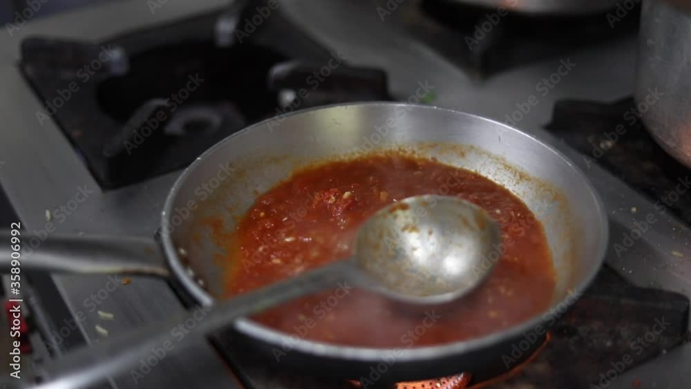Cooking red sauce, with sauteed vegetables, caramelised onions, red ...