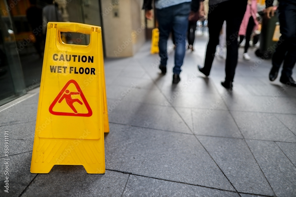 Safety workplace caution wet floor warning sign on the floor surfaces ...
