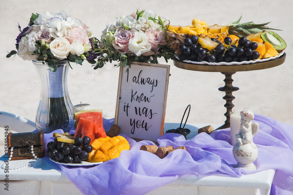 Wooden welcome table board sign at the wedding on the beach with ...