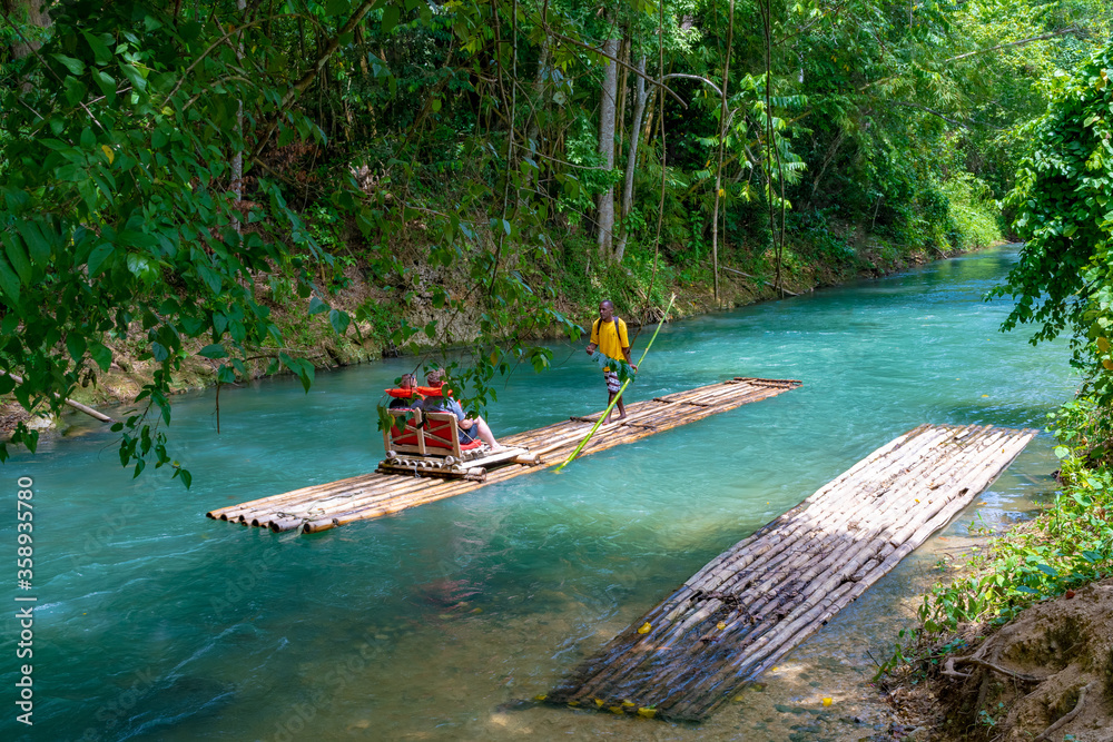 Falmouth, Jamaica. Tourists on bamboo raft ride on Martha Brae River ...
