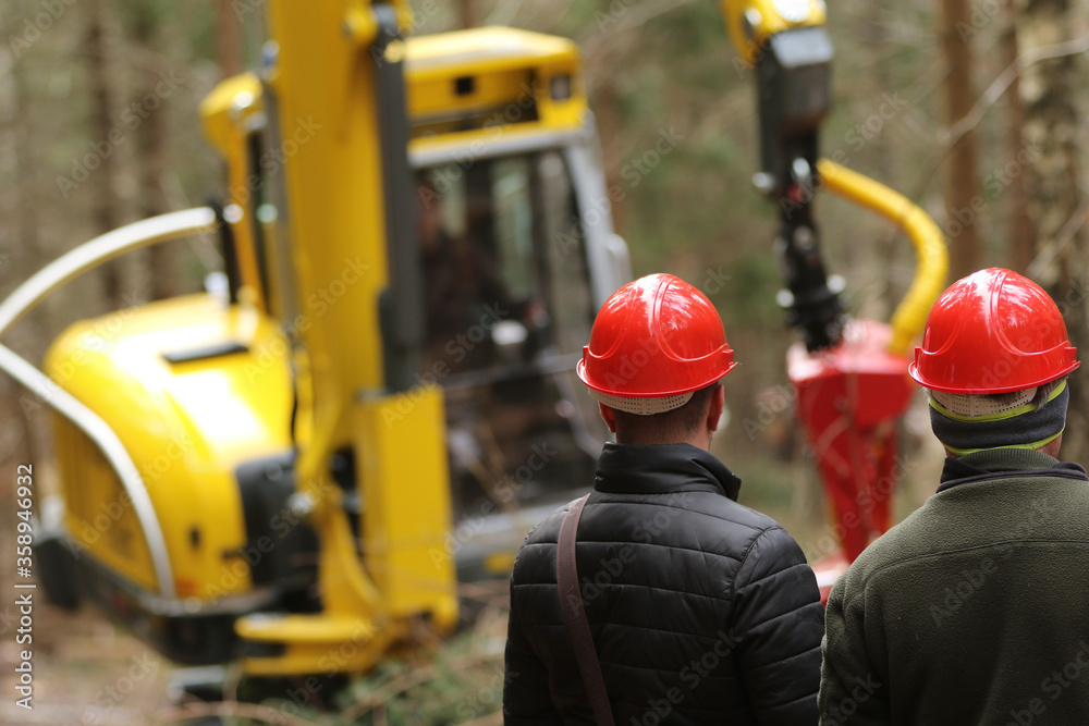 Demonstration of a new logging harvester into the forest. Demonstration ...