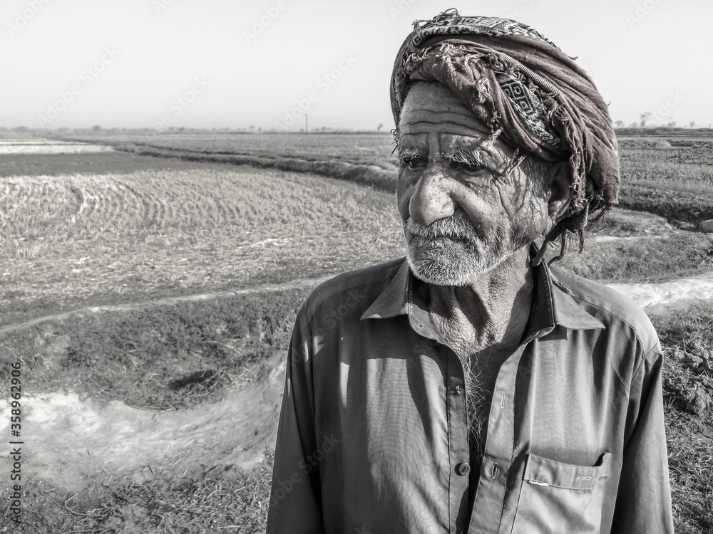 a homeless an old man wearing arabic traditional clothes and feeling ...