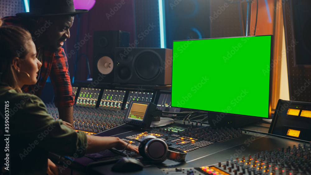 Producer and Audio Engineer Working together in Music Record Studio on ...