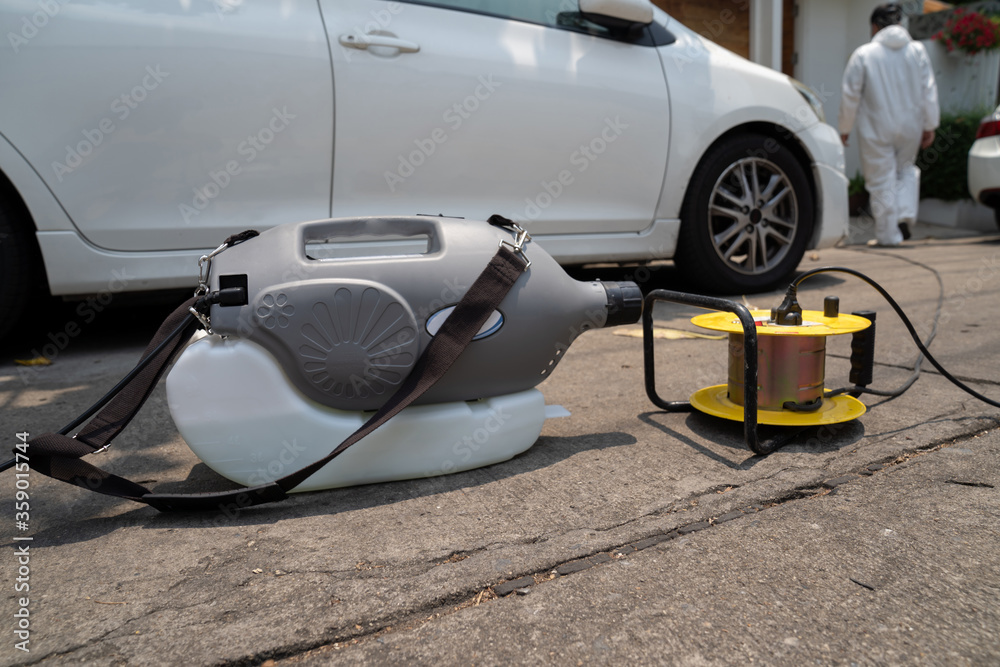 sterilizing machine water spray is standing in front of personal ...