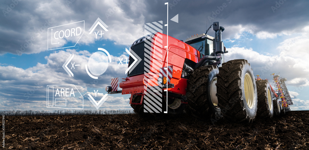 Autonomous remote controlled agricultural tractor on the field. Digital ...