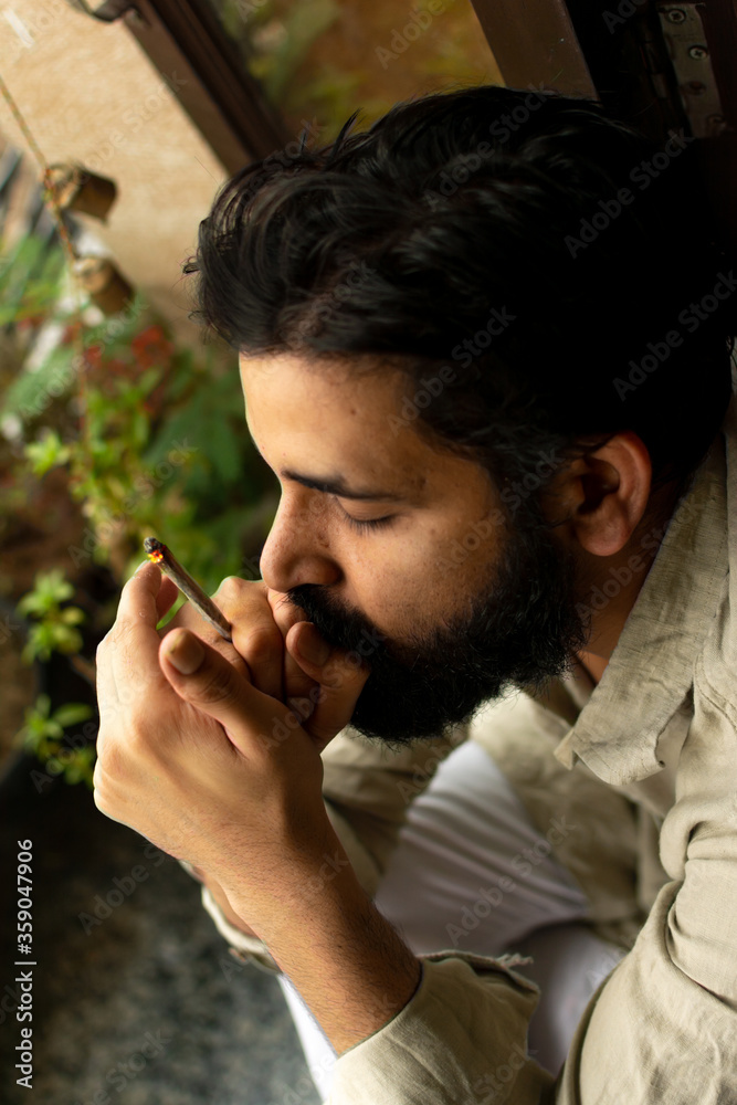 a bearded Indian man smoking weed Stock Photo | Adobe Stock