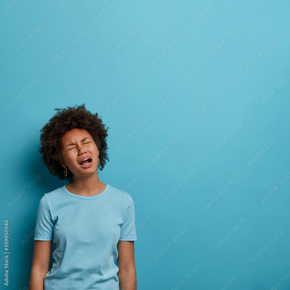 Vertical shot of disappointed desperate melancholic woman cries loudly ...