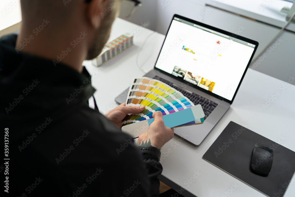 The color palette in the designer's hands while working at his ...